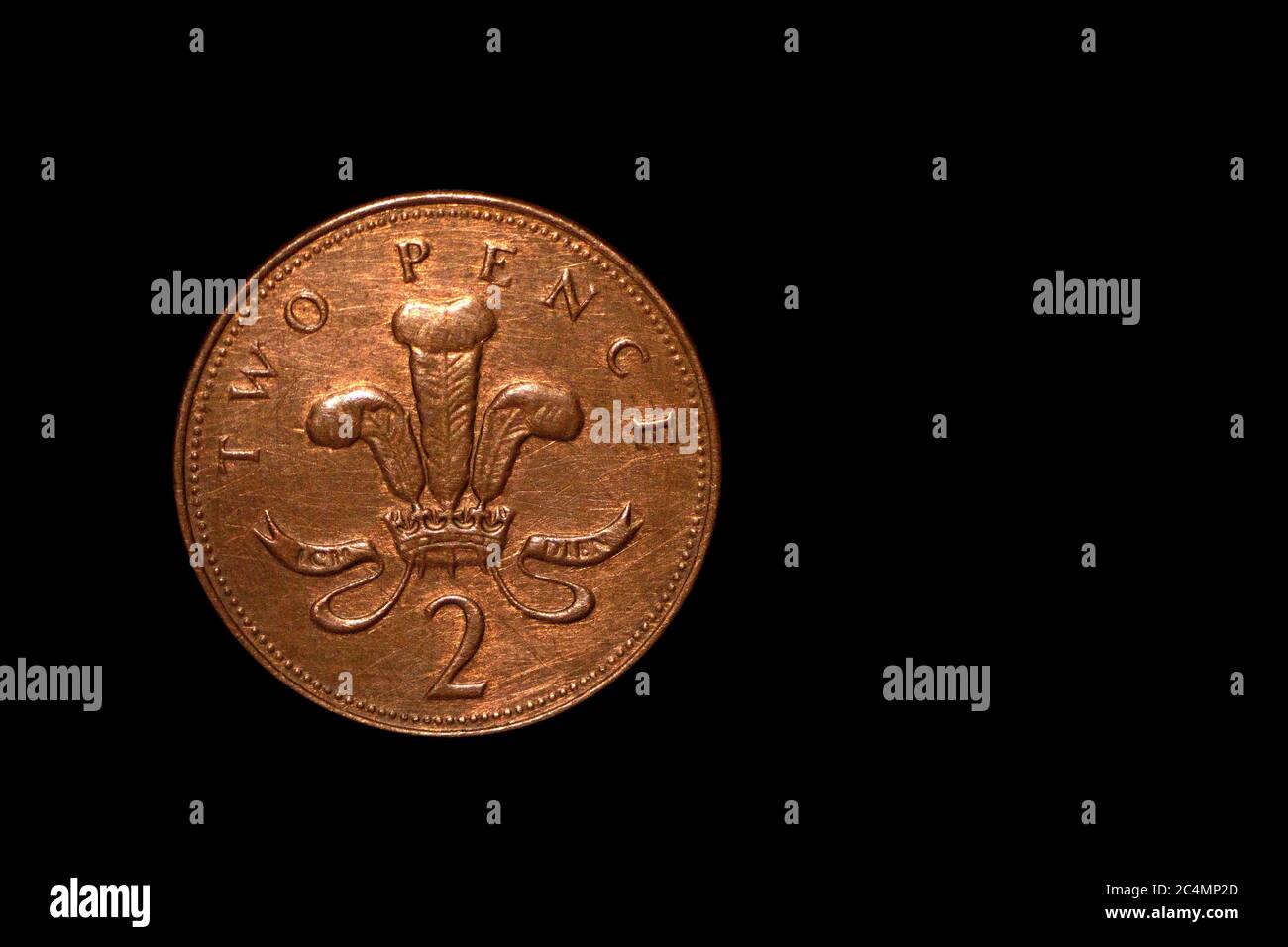 British coin 2 pence (2001) isolated on black background with space for ...