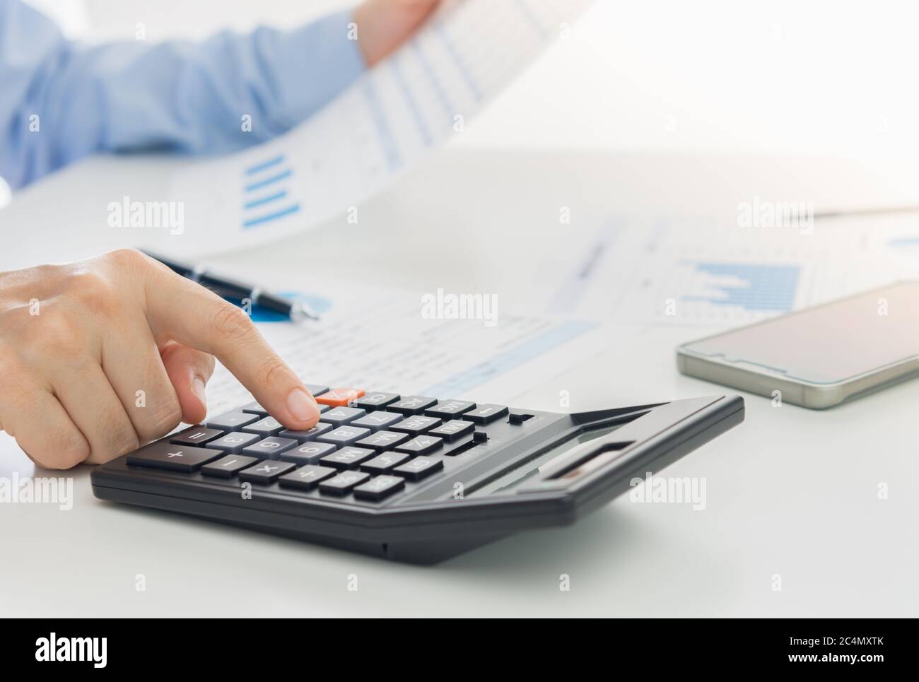 Businessman using a calculator to calculate the numbers. Accounting ...