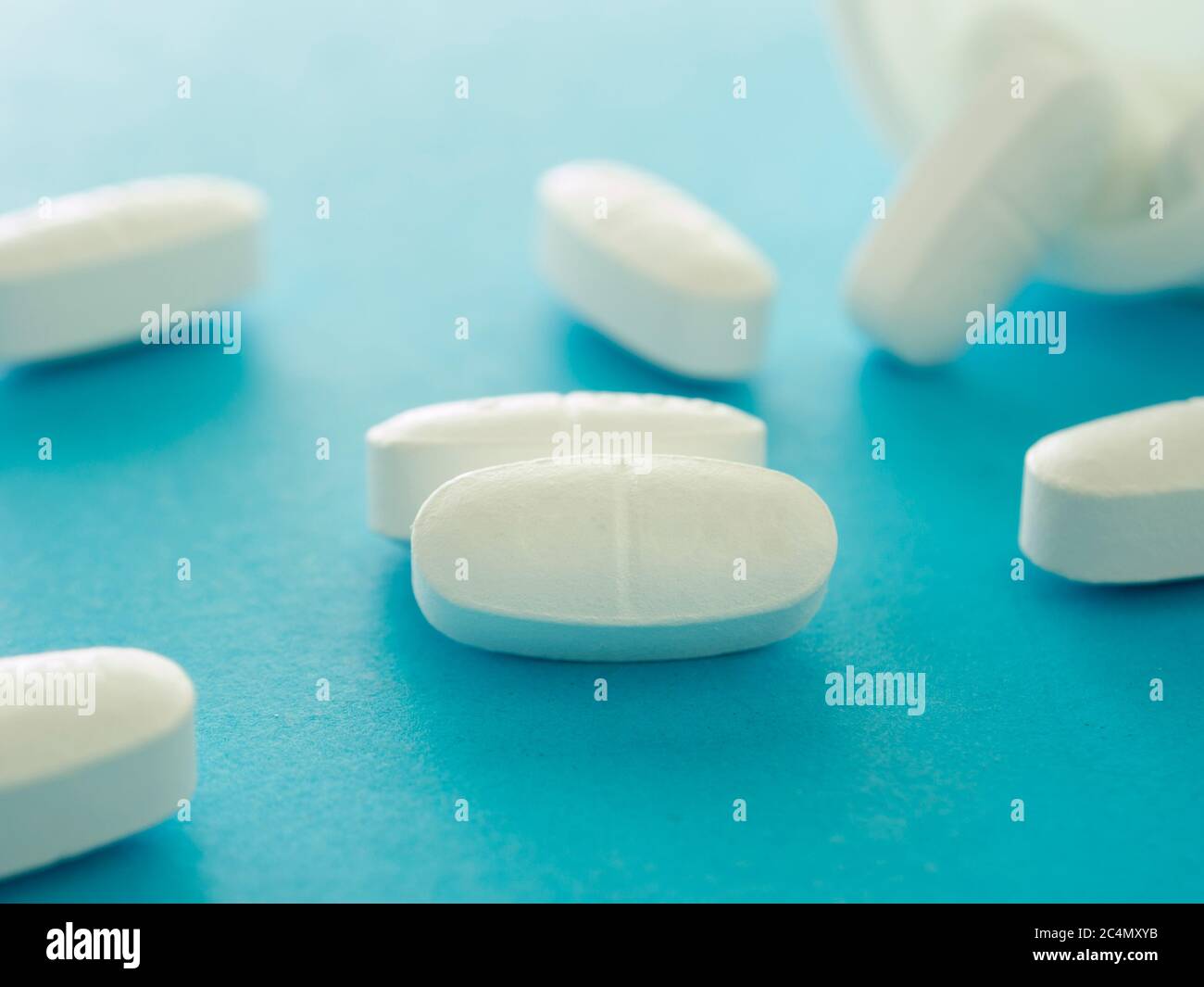 Medicine antibiotic tablet pills with medicine bottle on blue ...