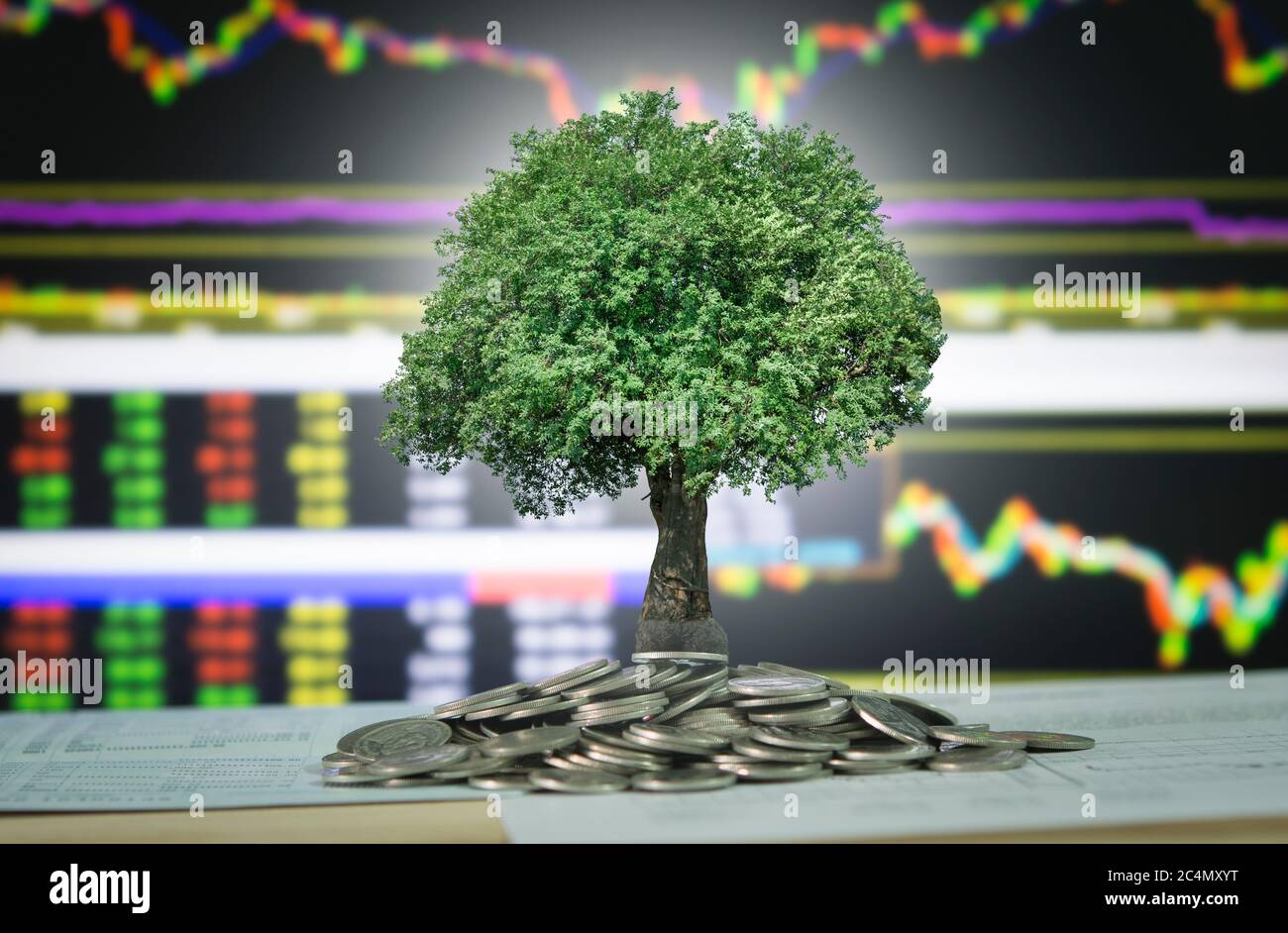 The tree are grow up on coins stack and stock marke chart and graph ...