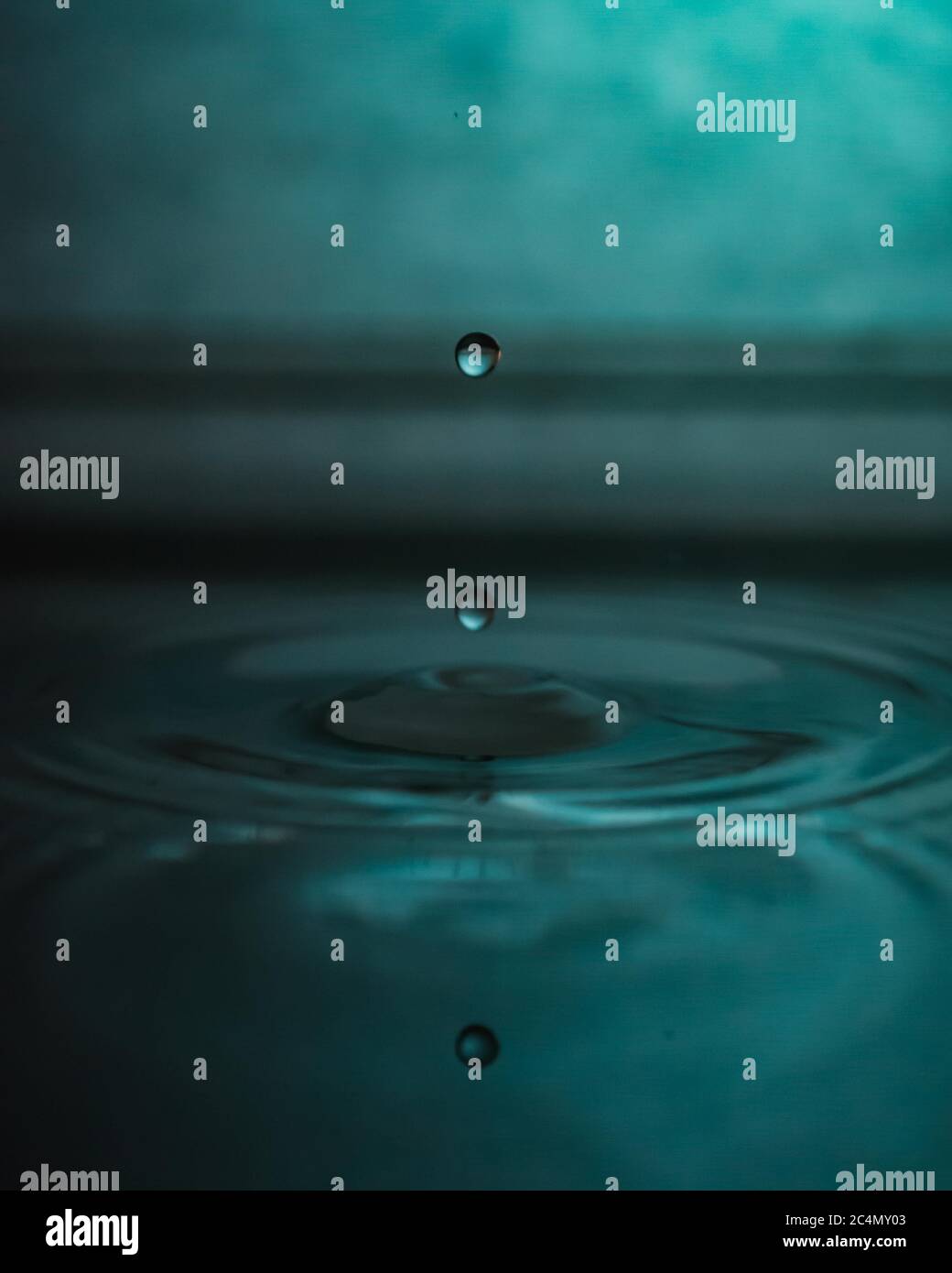 Water dripping and splashing with a blue effect Stock Photo - Alamy