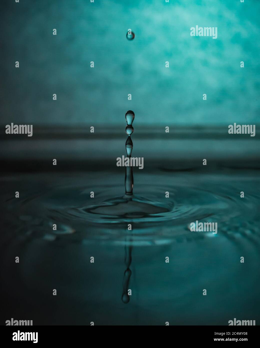 Water dripping and splashing with a blue effect Stock Photo - Alamy