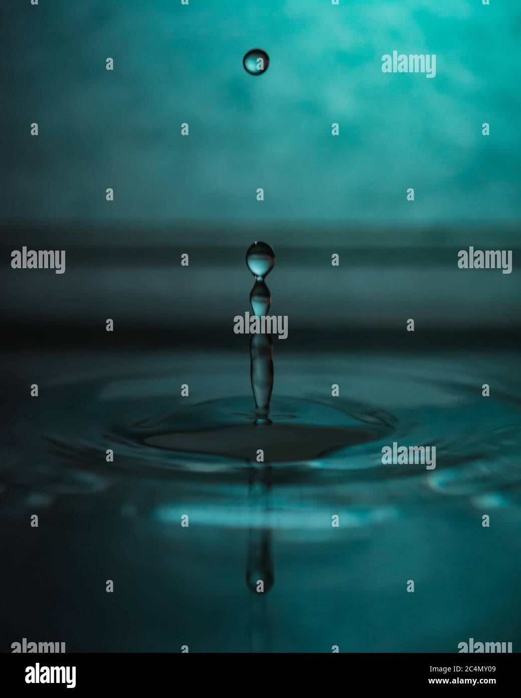Water dripping and splashing with a blue effect Stock Photo - Alamy