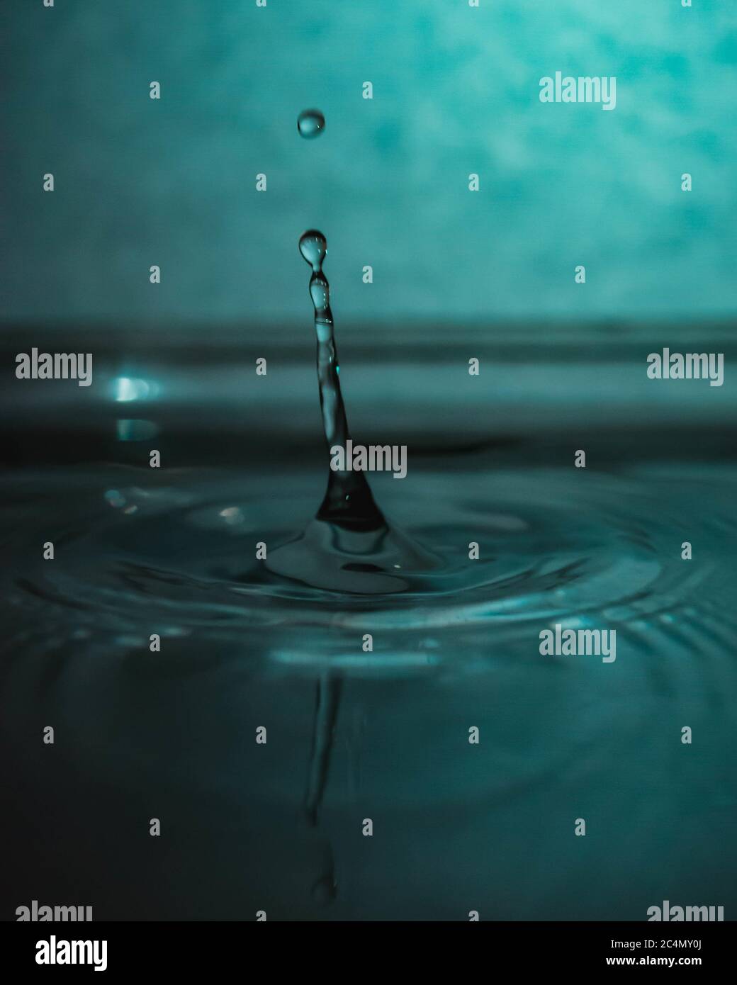 Water dripping and splashing with a blue effect Stock Photo - Alamy
