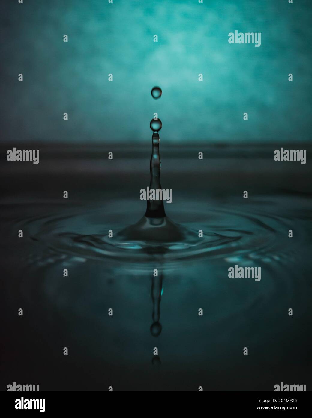 Water dripping and splashing with a blue effect Stock Photo - Alamy