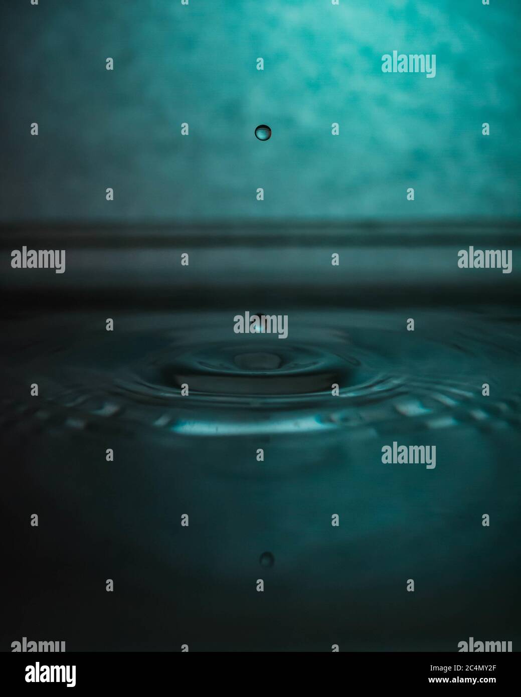 Water dripping and splashing with a blue effect Stock Photo - Alamy