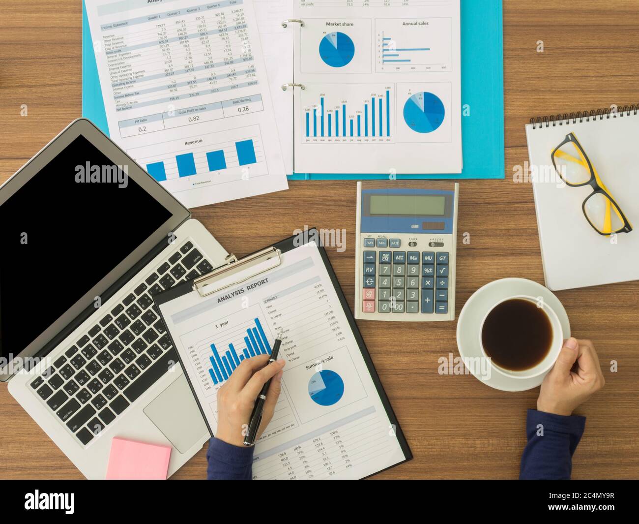 Financial analyst analyzing business data on desk. top view. Accounting ...