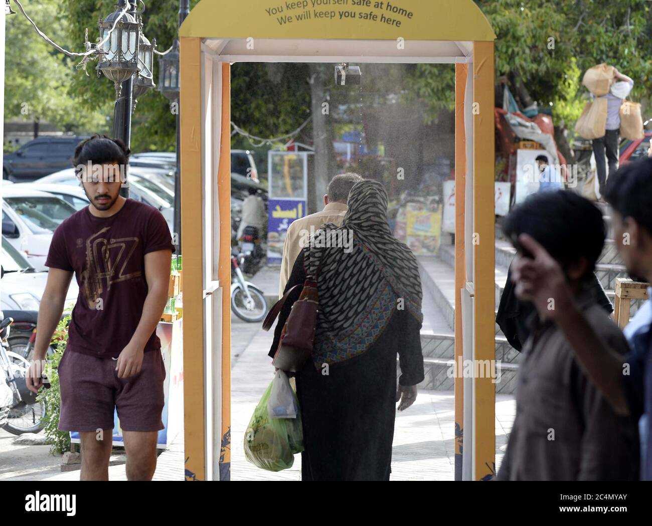 Islamabad, Pakistan. 27th June, 2020. A woman walks trough a ...