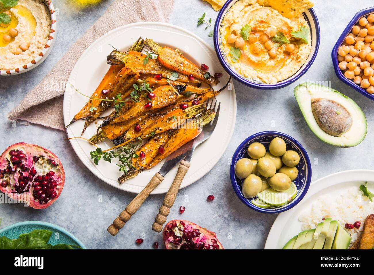Variety of healthy vegan snacks, gourmet dips. Hummus, roasted carrots ...