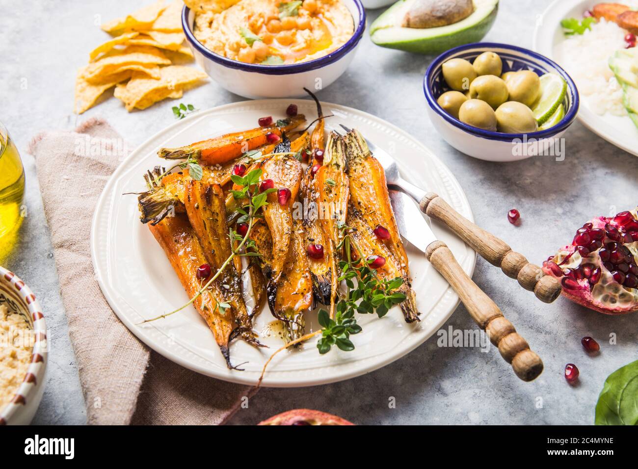 Variety of healthy vegan snacks, gourmet dips. Hummus, roasted carrots ...