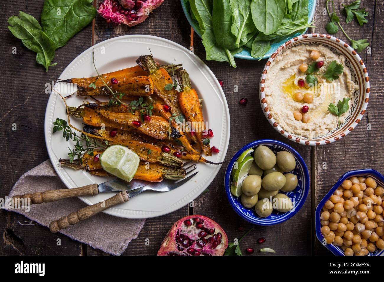 Variety of healthy vegan snacks, gourmet dips. Hummus, roasted carrots ...