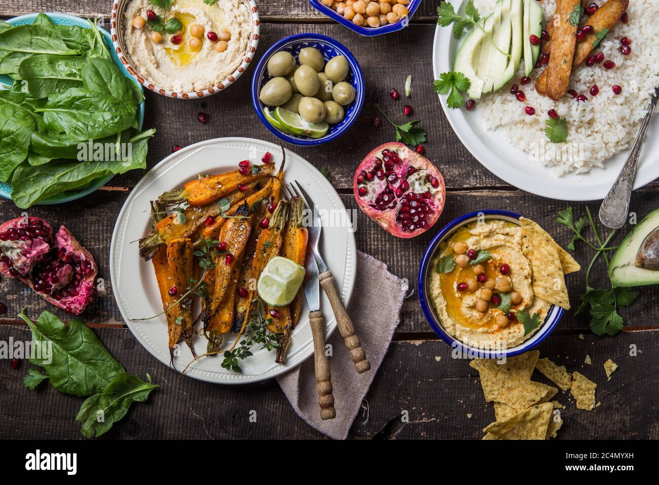 Variety of healthy vegan snacks, gourmet dips. Hummus, roasted carrots ...