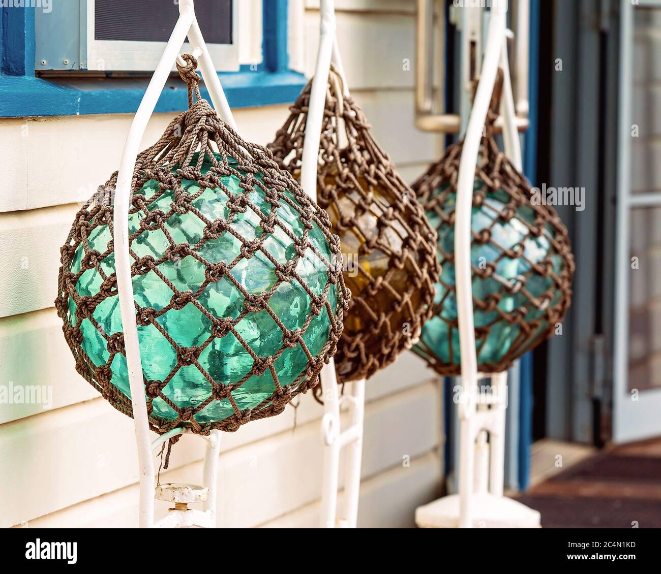 Round glass marker buoys covered with fishnet at a maritime museum ...