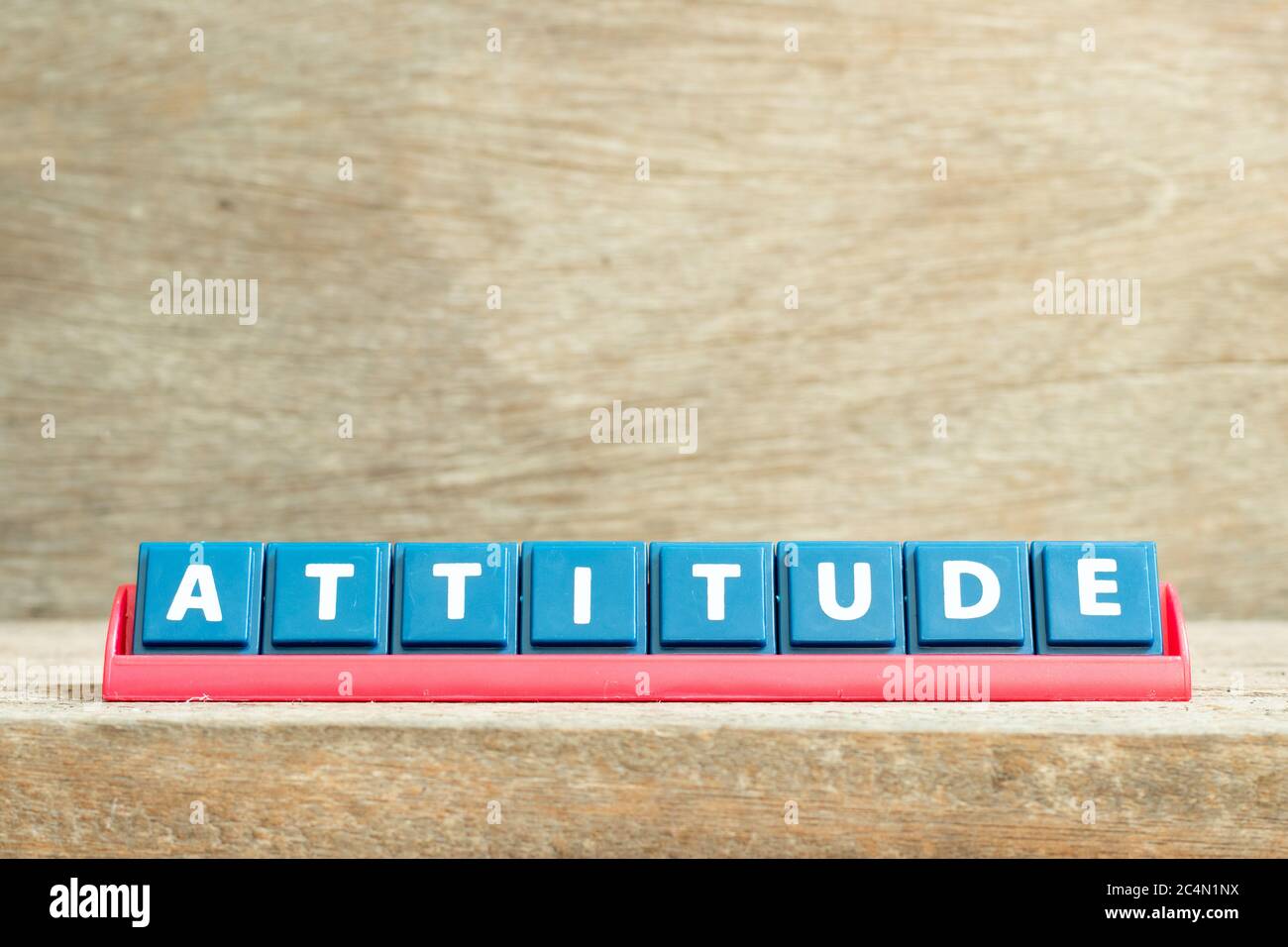 Tile letter on red rack in word attitude on wood background Stock Photo ...