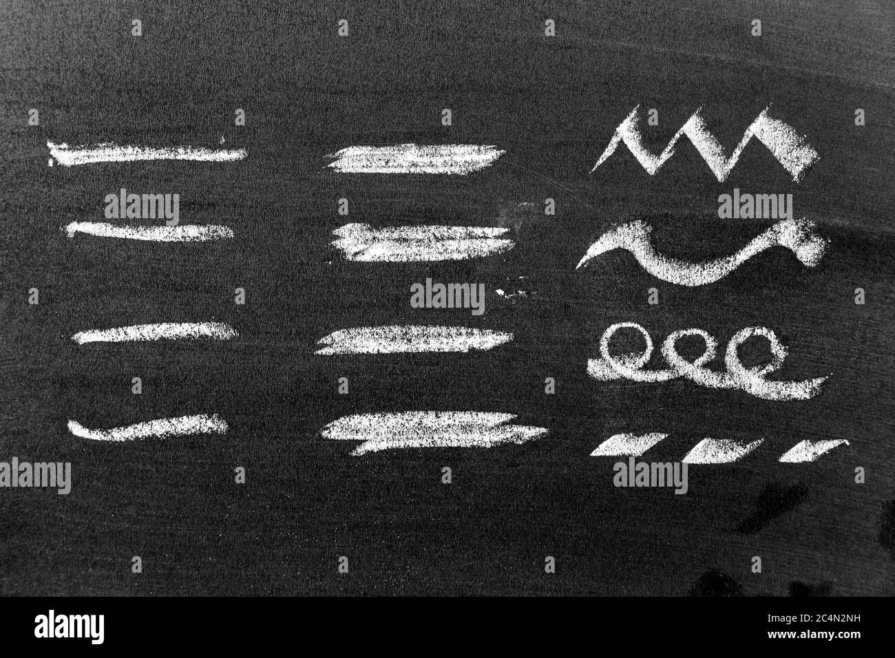White color chalk hand drawing in set of line shape on black board ...