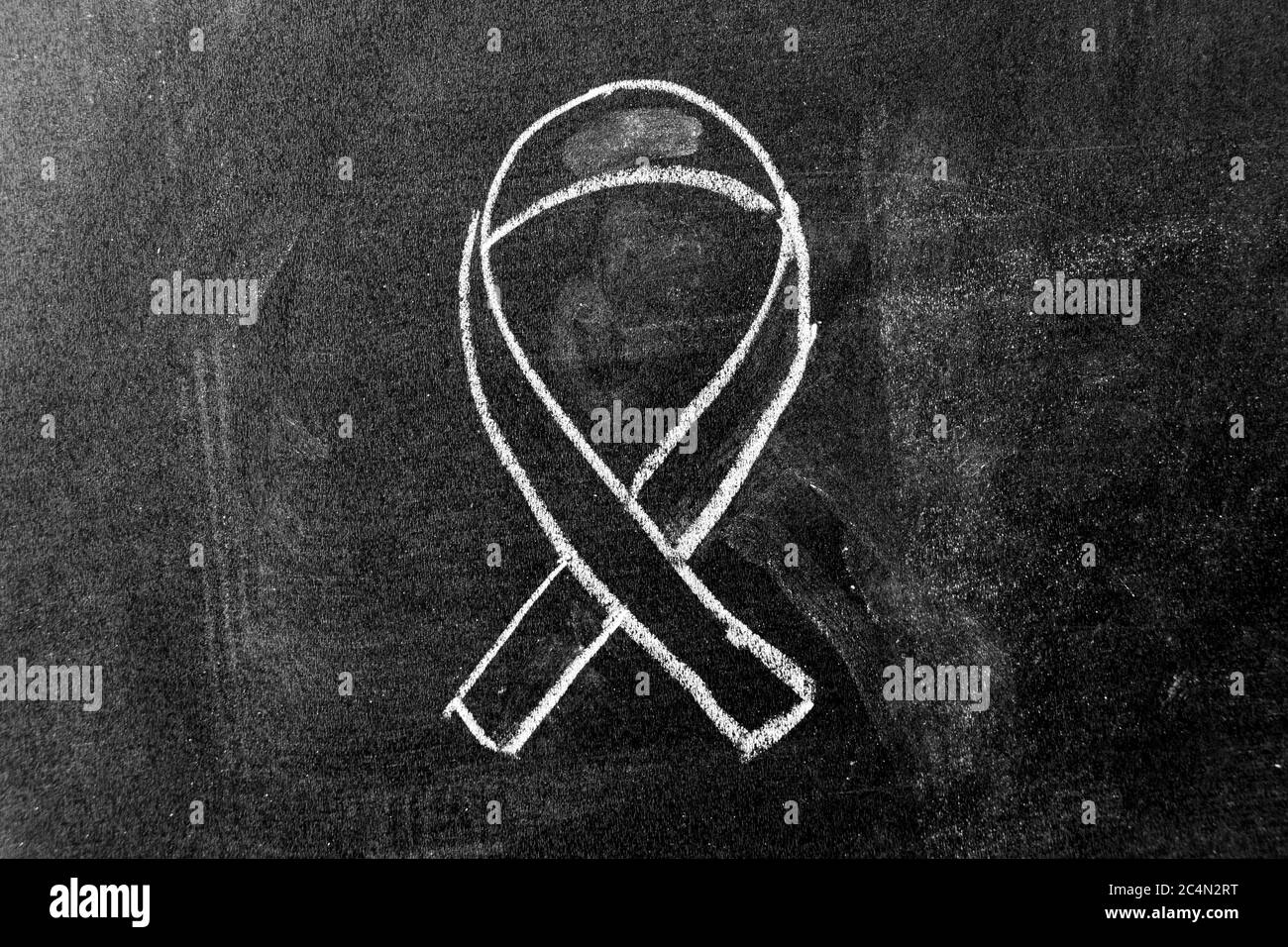 White color chalk drawing as black ribbon shape on black board ...