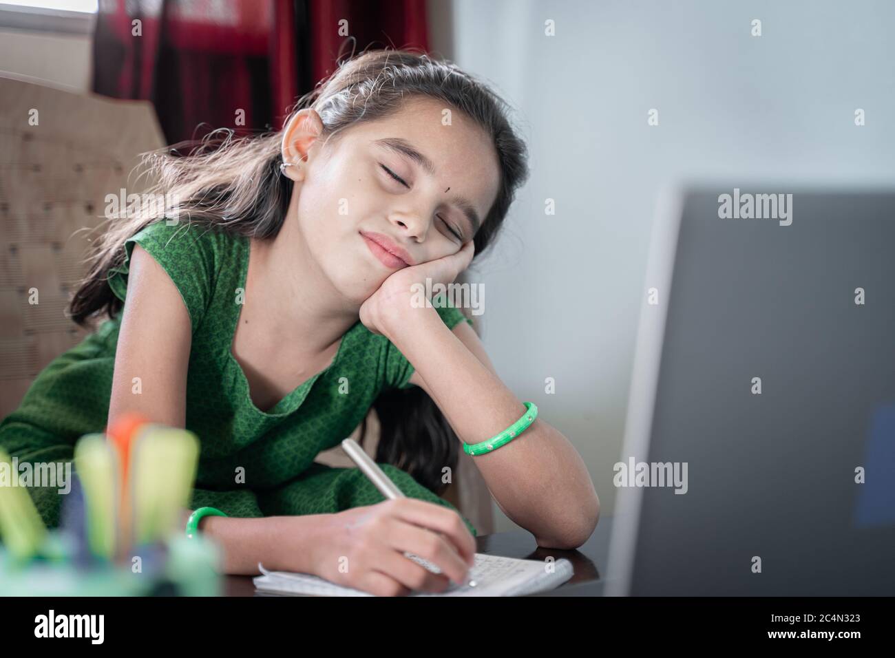 Girl child sleeping during online class infront of laptop - concept of ...