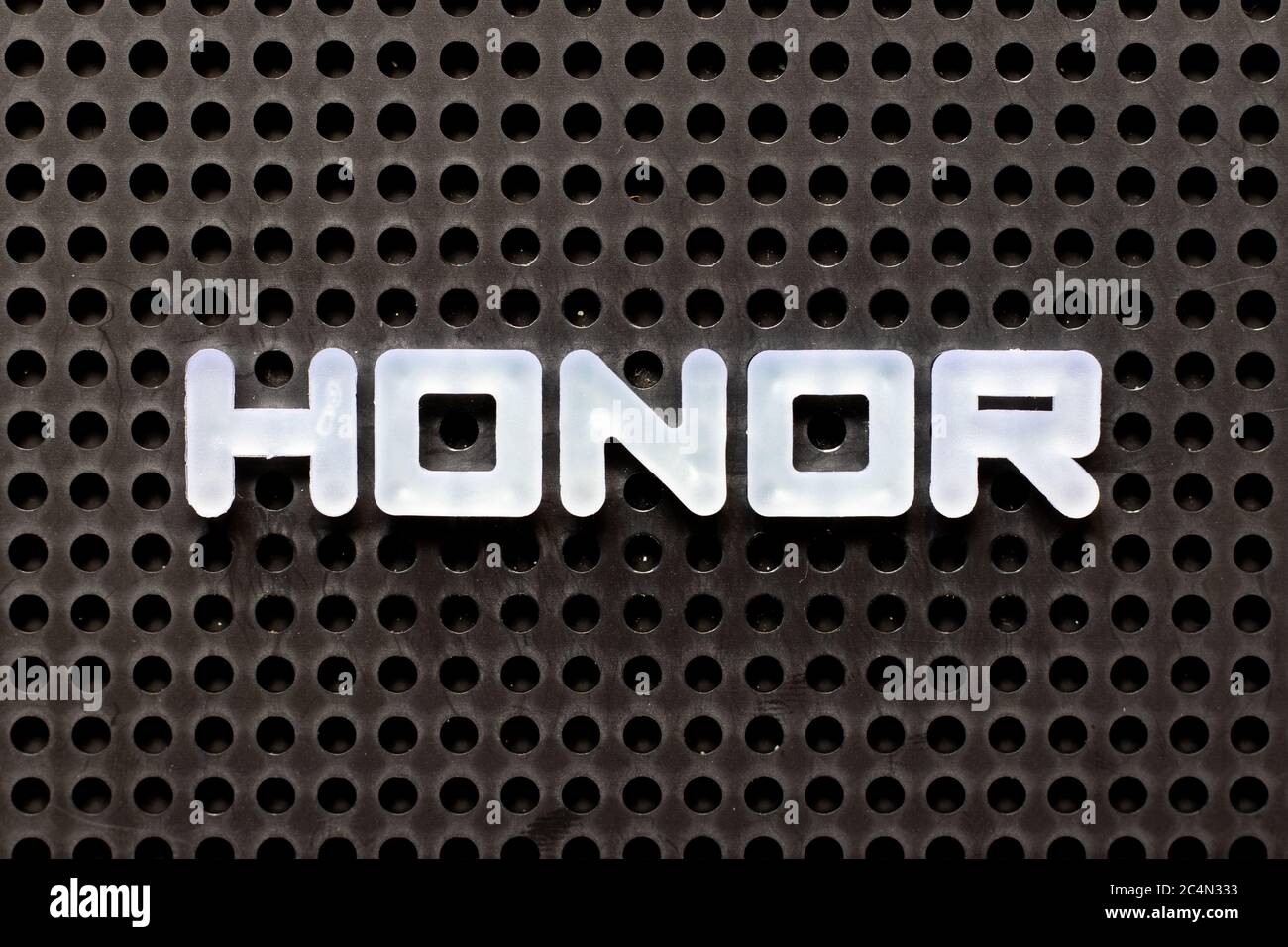 White color alphabet with word honor on black pegboard background Stock ...