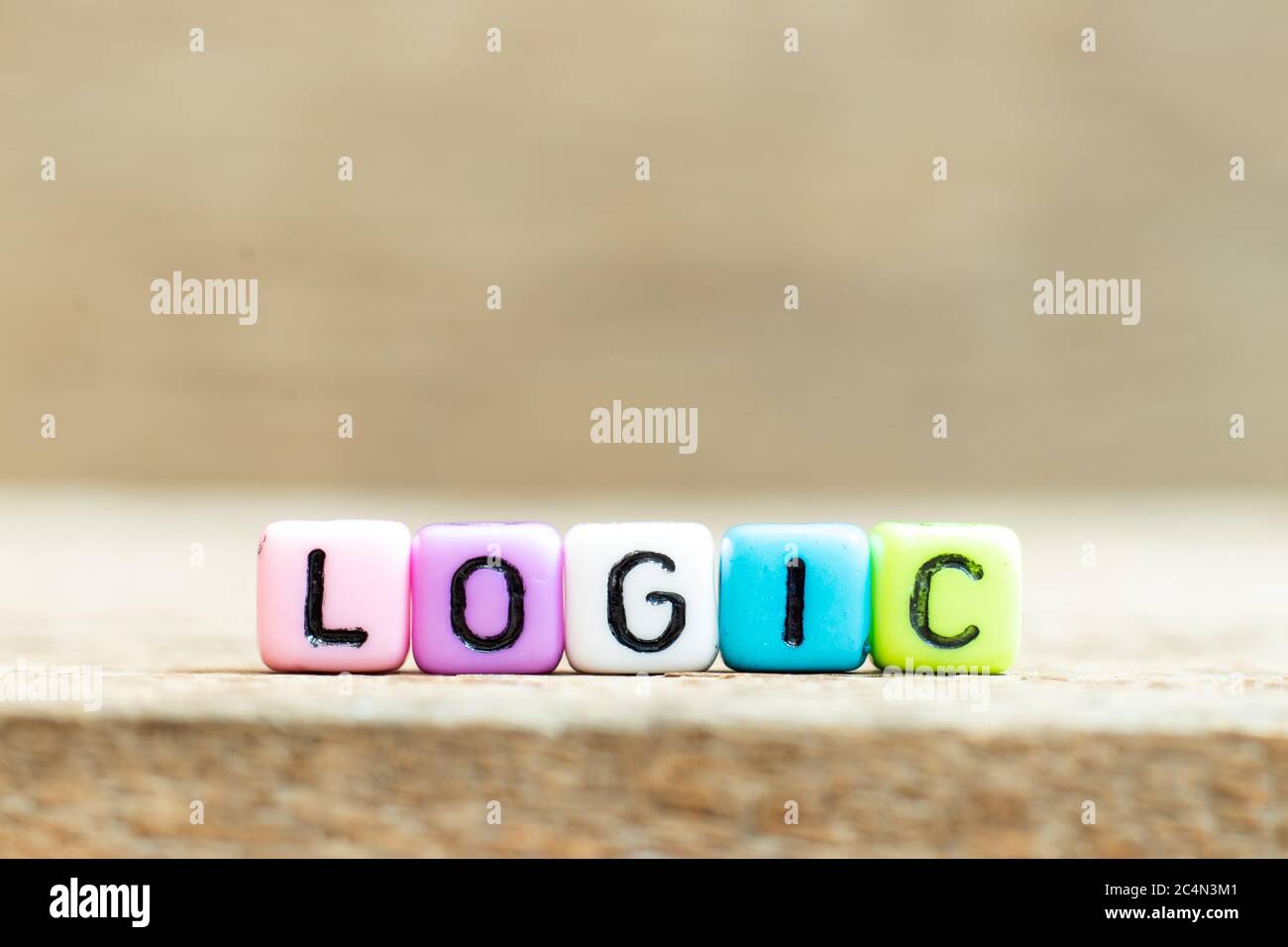 Colorful bead with black letter in word logic on wood background Stock ...