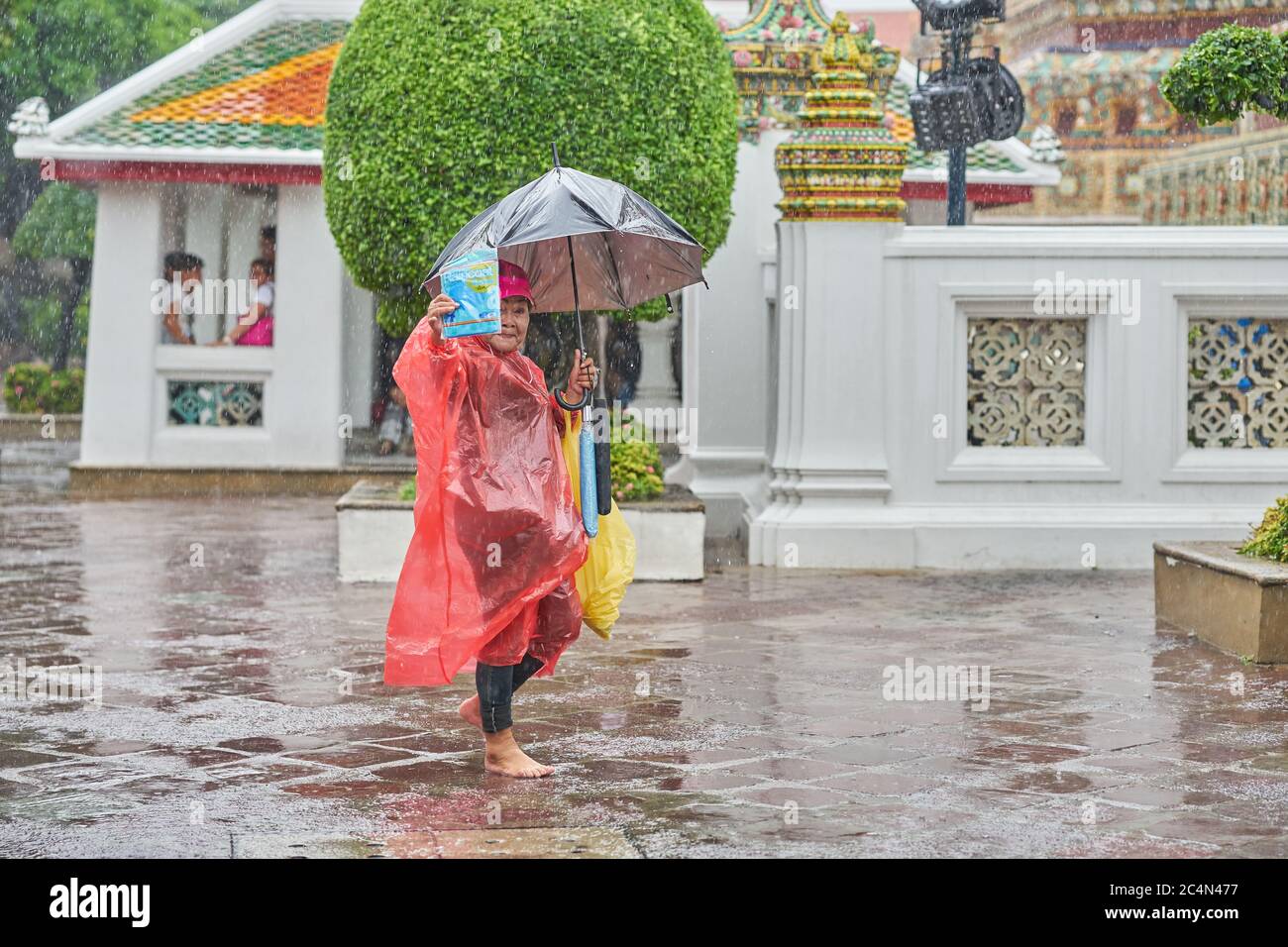 Selling maps at a tourist attraction in Bangkok, on a rainy day Stock ...