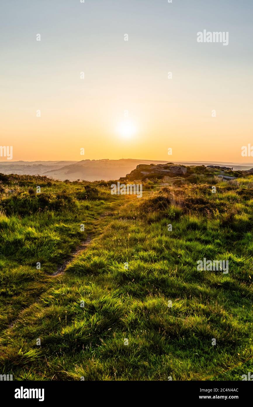 Following the path along Curbar Edge on a clear evening with a ...