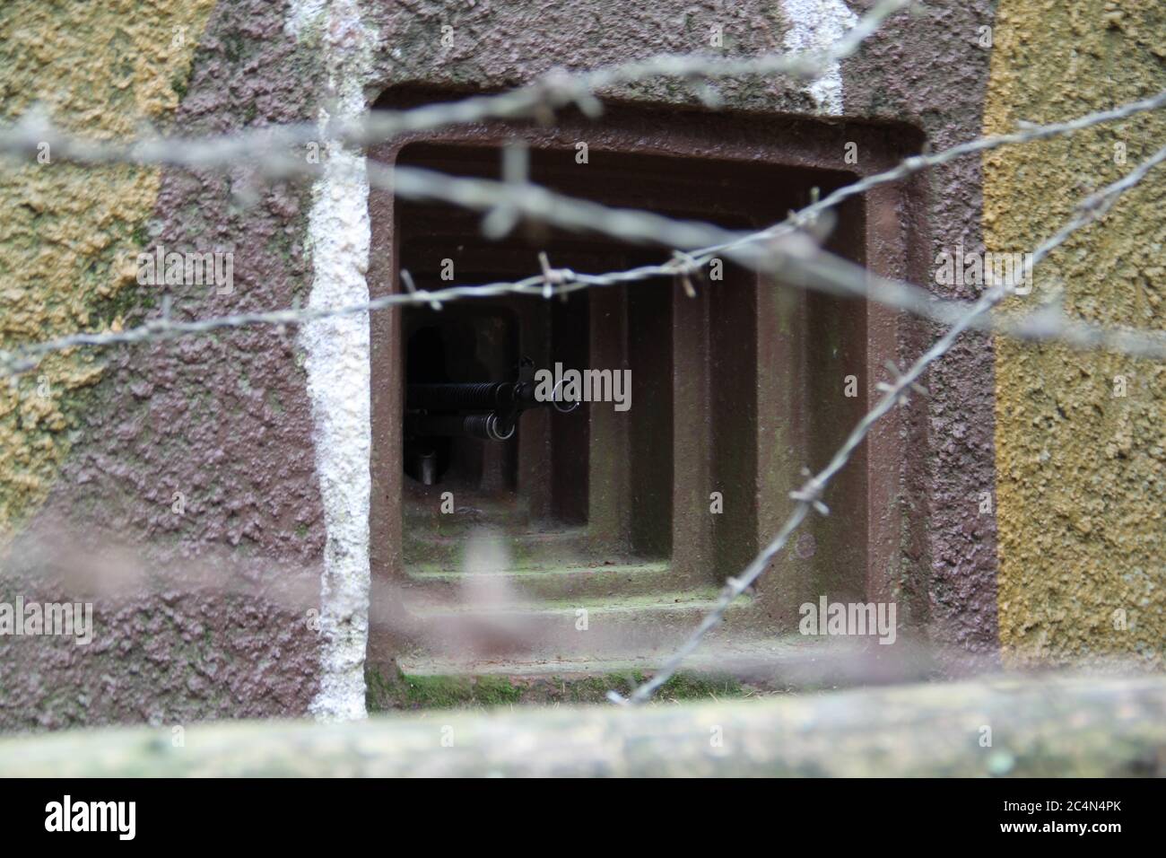 Hidden sniper in a military shelter with a barbed wire fence Stock ...