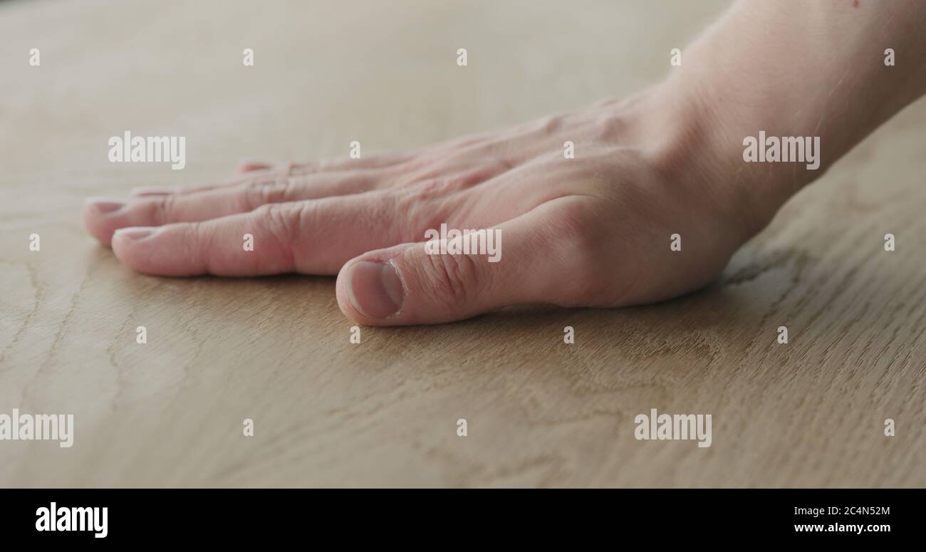 man hand check quality of oak wood surface Stock Photo - Alamy