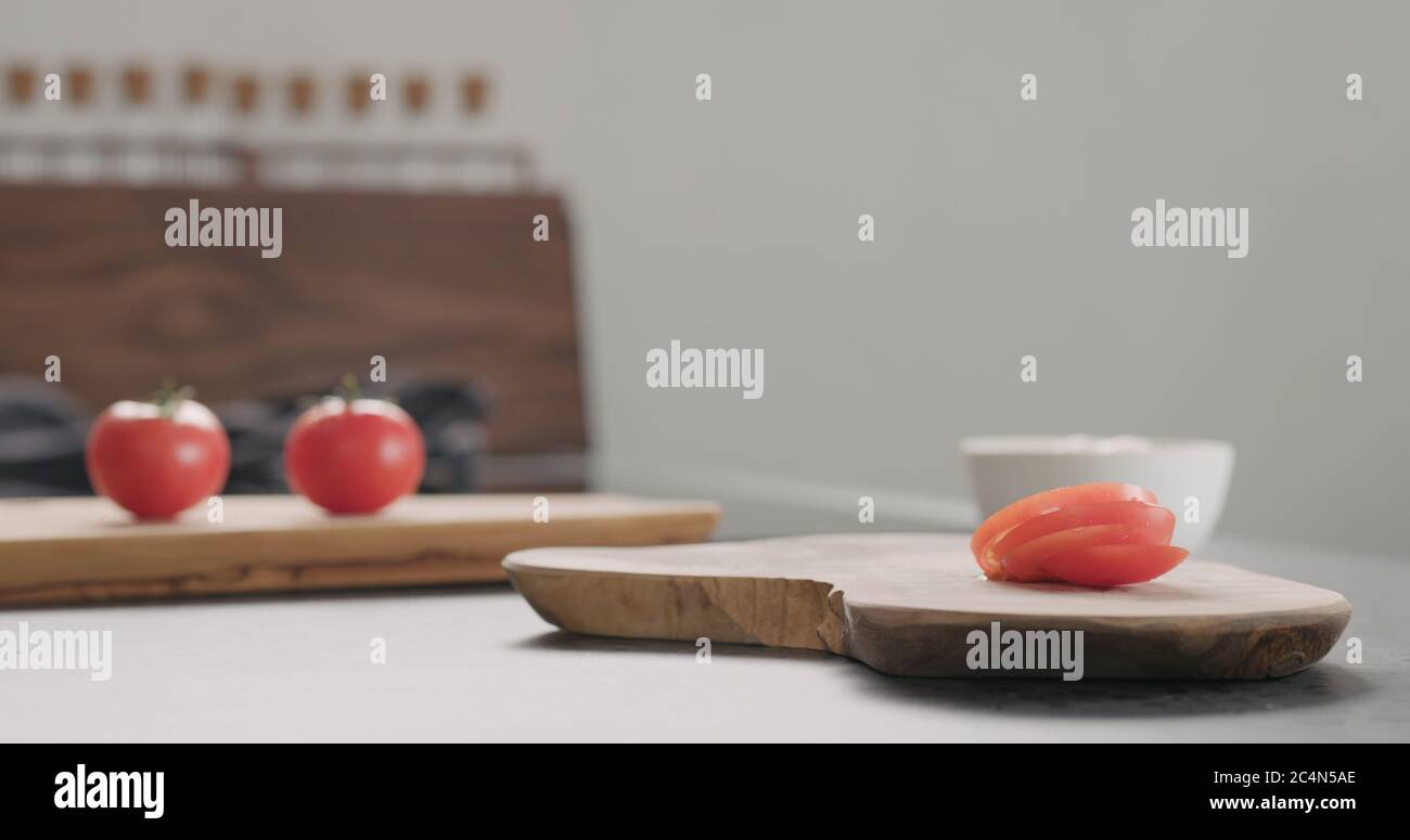 sliced tomato from olive wood board Stock Photo - Alamy