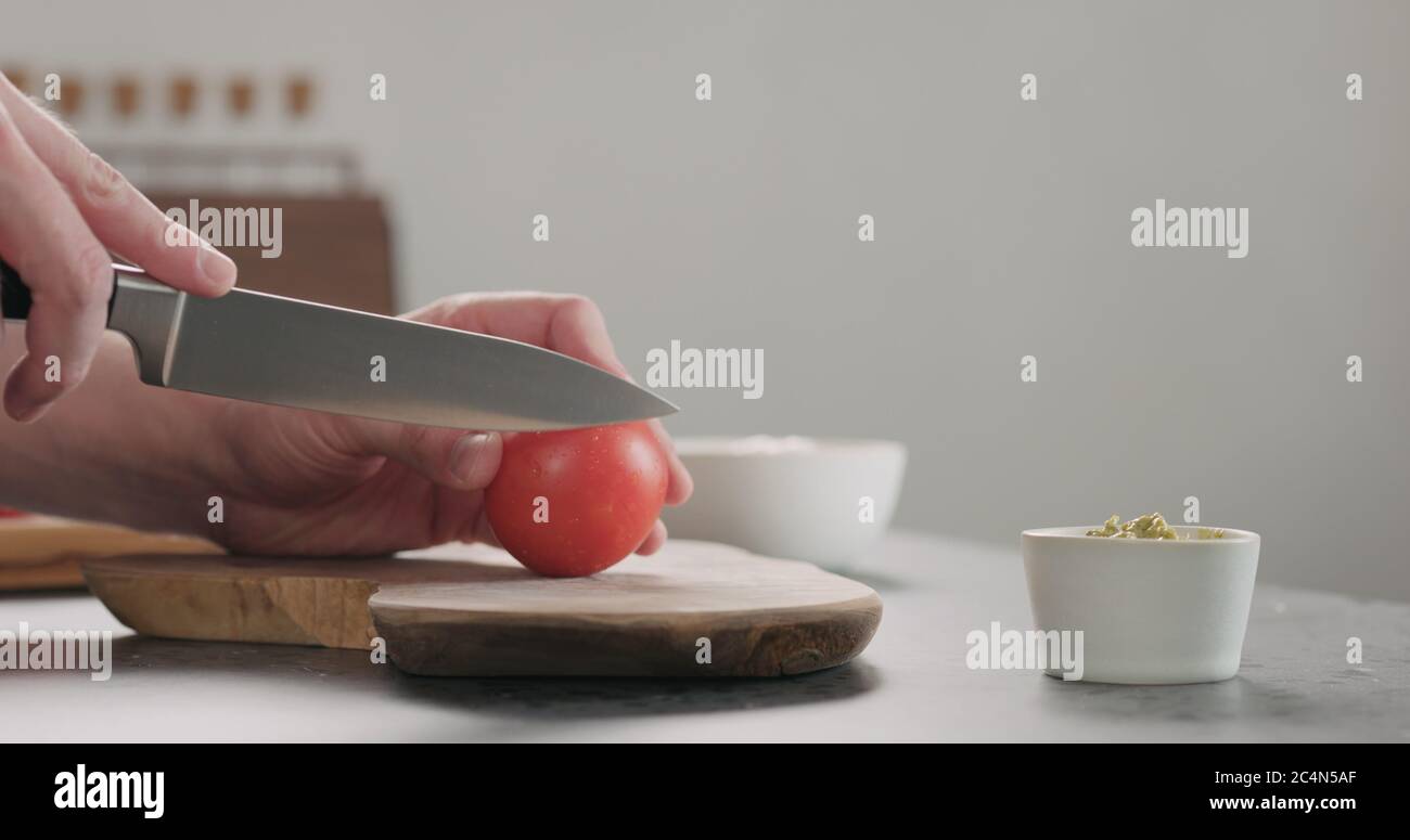 Male hand cutting tomato on hi-res stock photography and images - Alamy