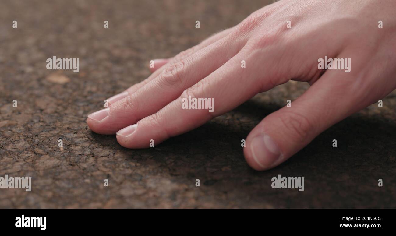 man hand touch dark cork surface with oil finish Stock Photo - Alamy