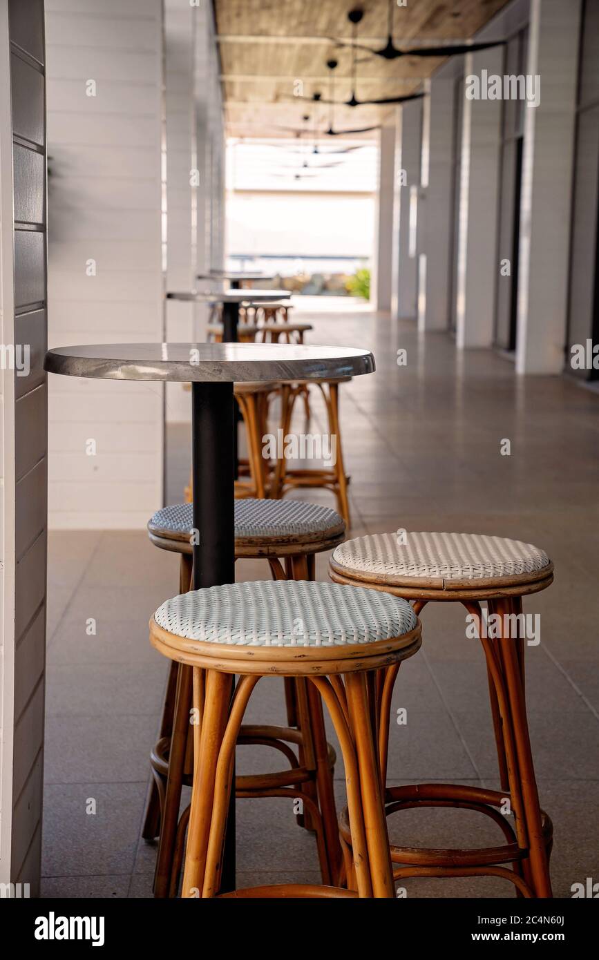 Bar table and stools in an outdoor hallway Stock Photo - Alamy