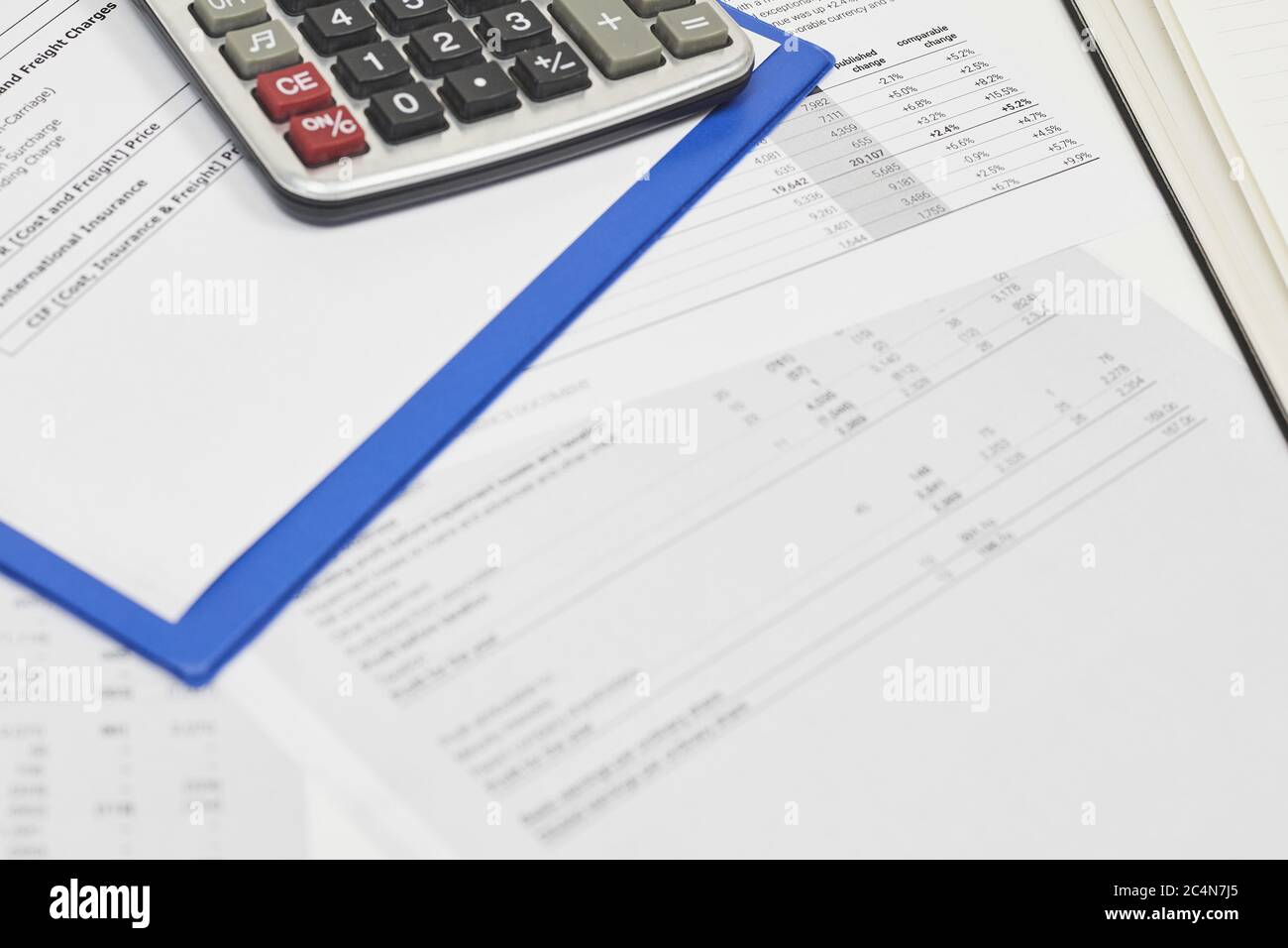 Calculator over several documents and files Stock Photo - Alamy
