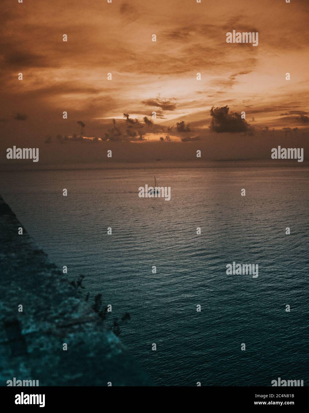 Breathtaking view of the sea gleaming under the red cloudy sky - great ...