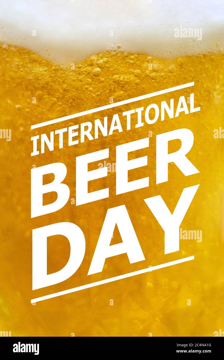 Closeup of a glass of yellow foamy craft beer with "international Beer ...