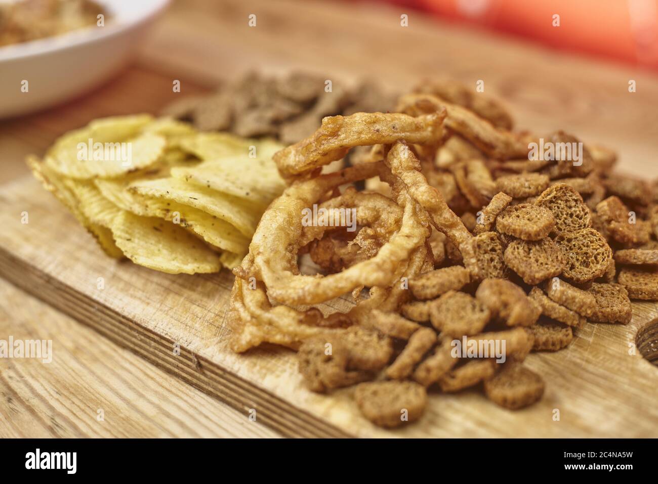 Closeup shot of chips, onion rings and other types of snacks Stock ...