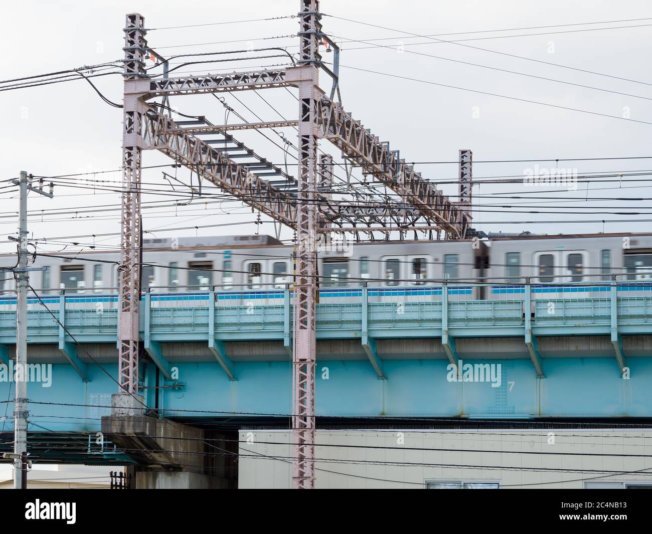 The elevated Chuo Line railway track and overhead electric gantry in ...