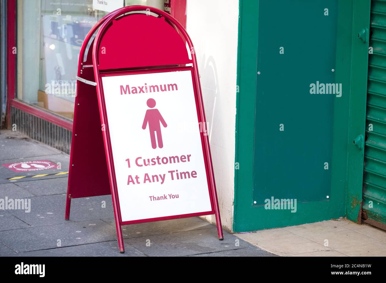 Social distancing sign for shop customer queue Stock Photo - Alamy