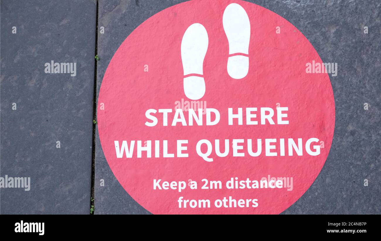 Social distancing sign for shop customer queue Stock Photo - Alamy