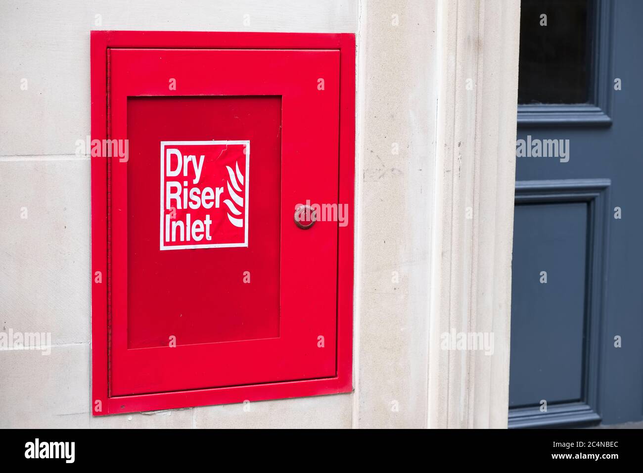 Dry riser red inlet box and sign at wall Stock Photo - Alamy