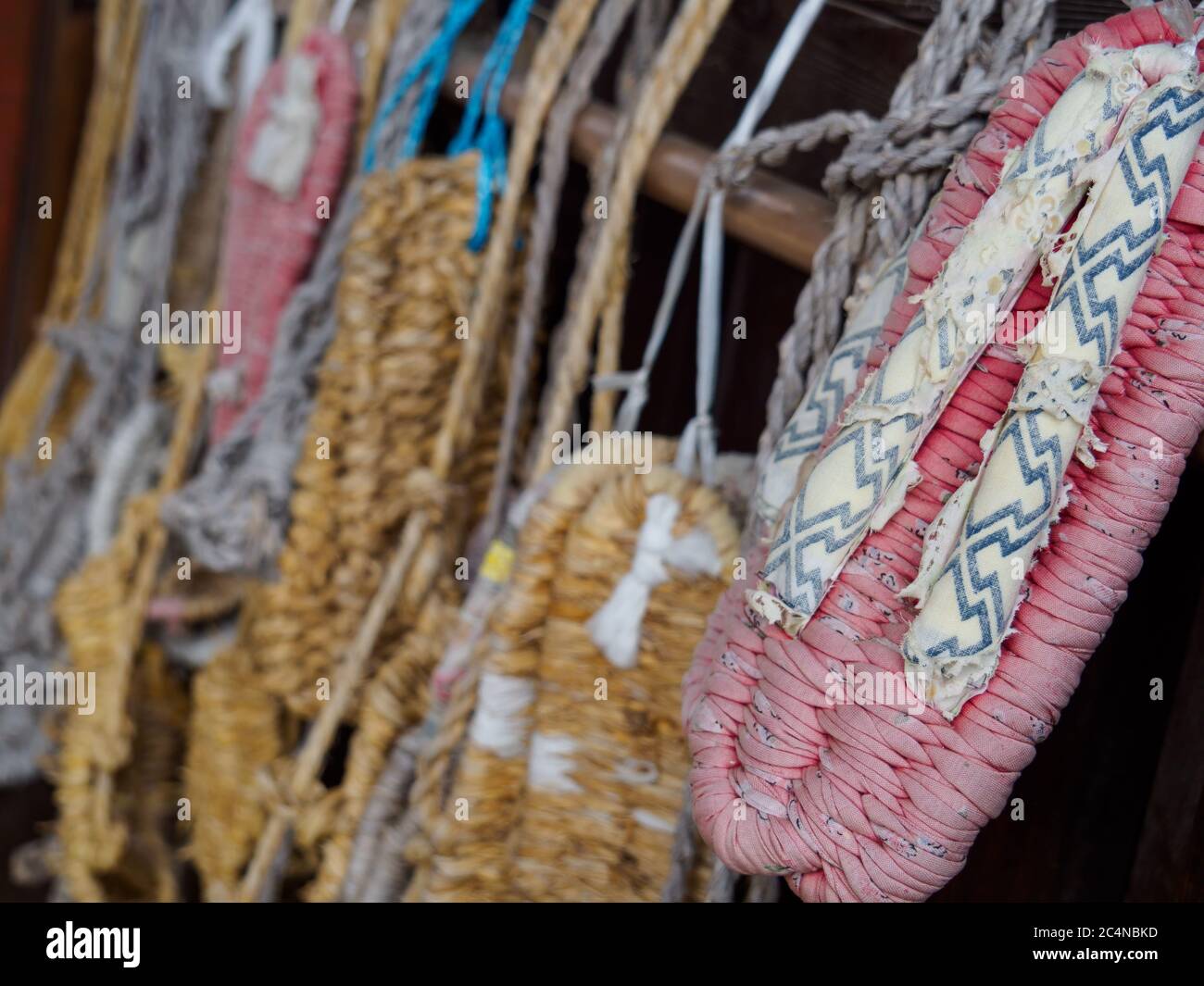 Traditional rice straw shoes called zori, hanging in an temple in Japan ...