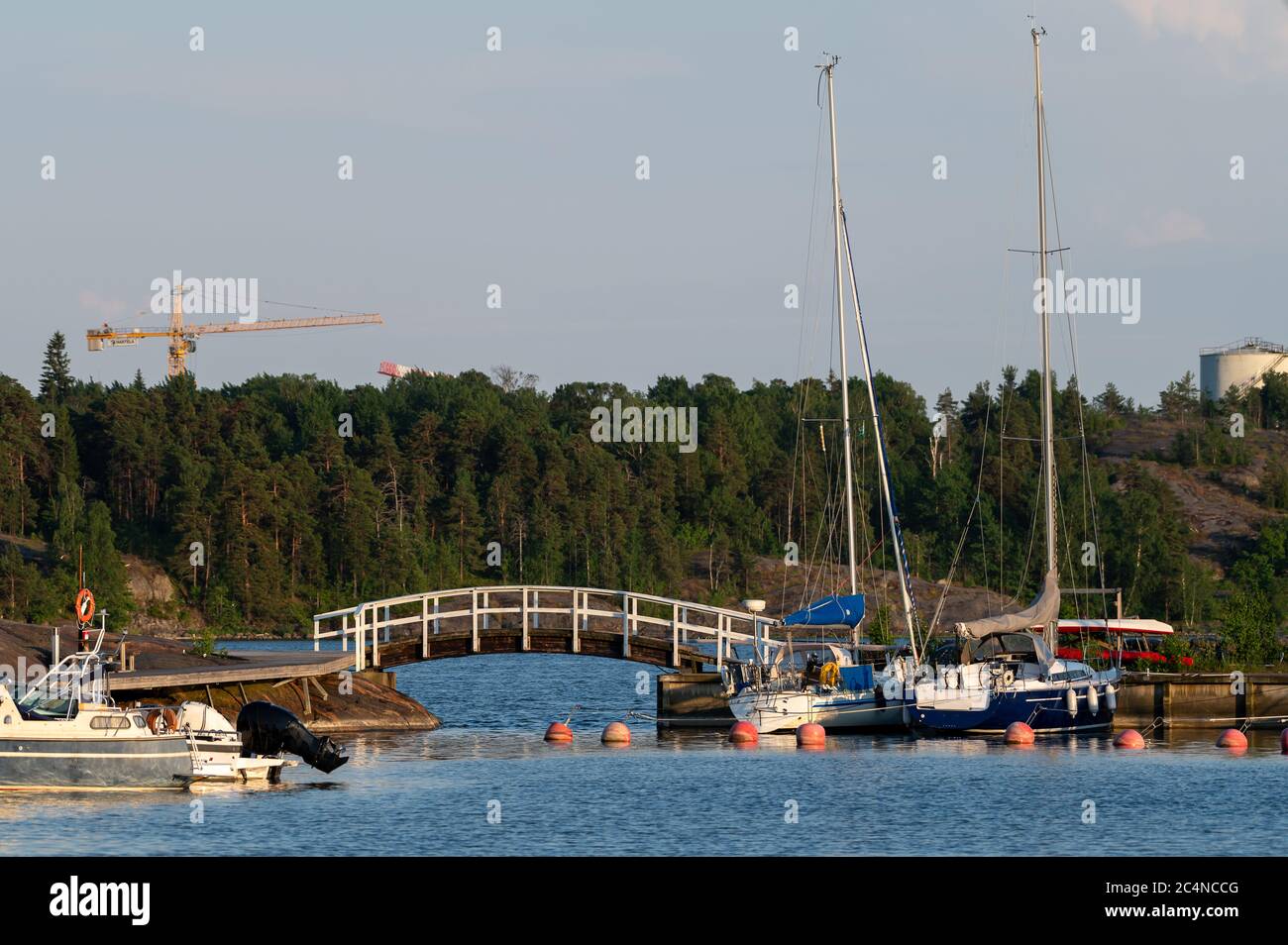 A traditional Scandinavian wooden walking bridge connecting two small ...