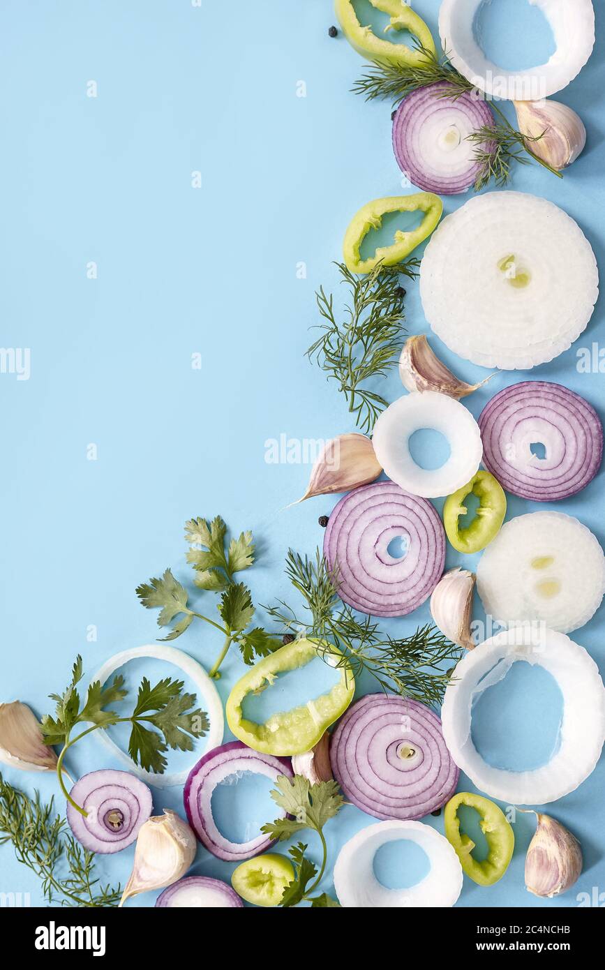 Slices of vegetables in a triangular pattern over a blue background ...