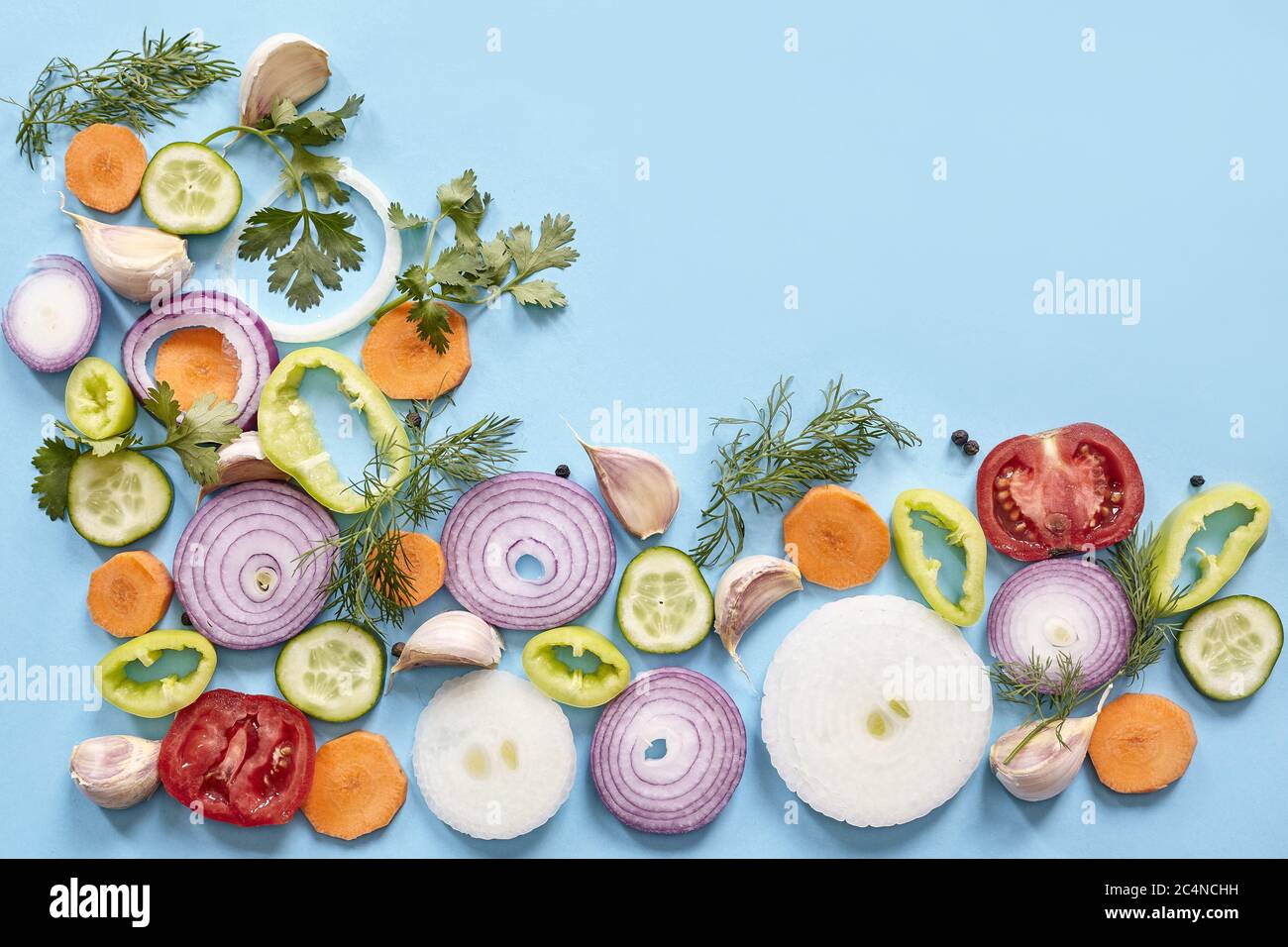 Slices of vegetables in a triangular pattern over a blue background ...
