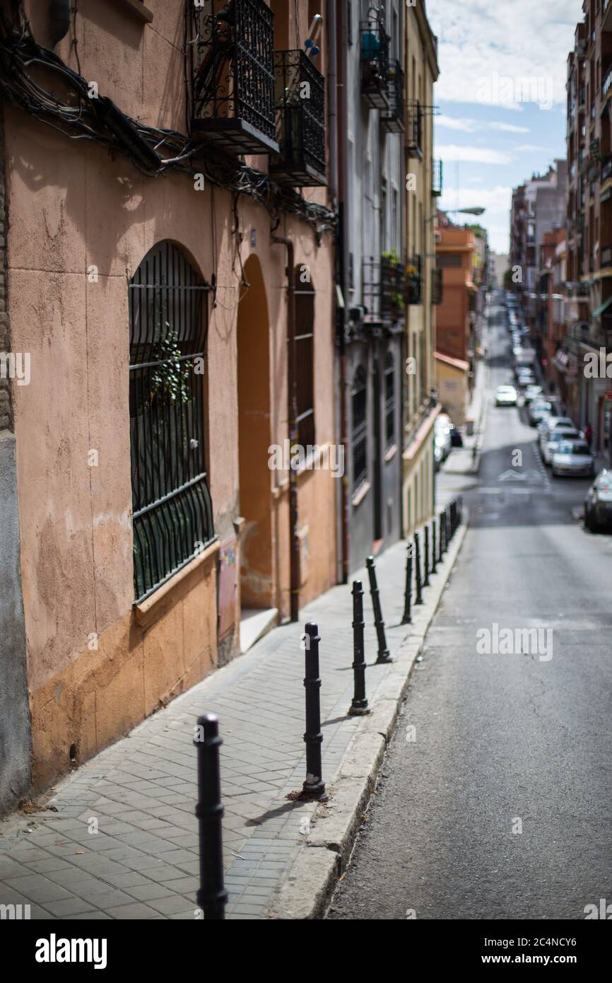 Long road and a sidewalk in a beautiful town with unique colorful ...