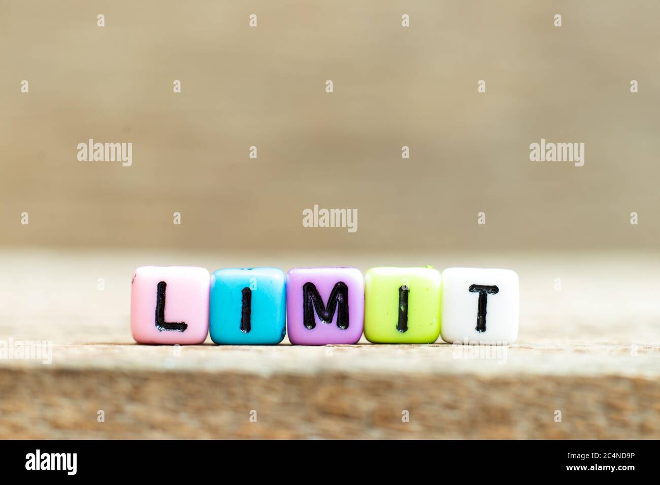 Colorful bead with black letter in word limit on wood background Stock ...
