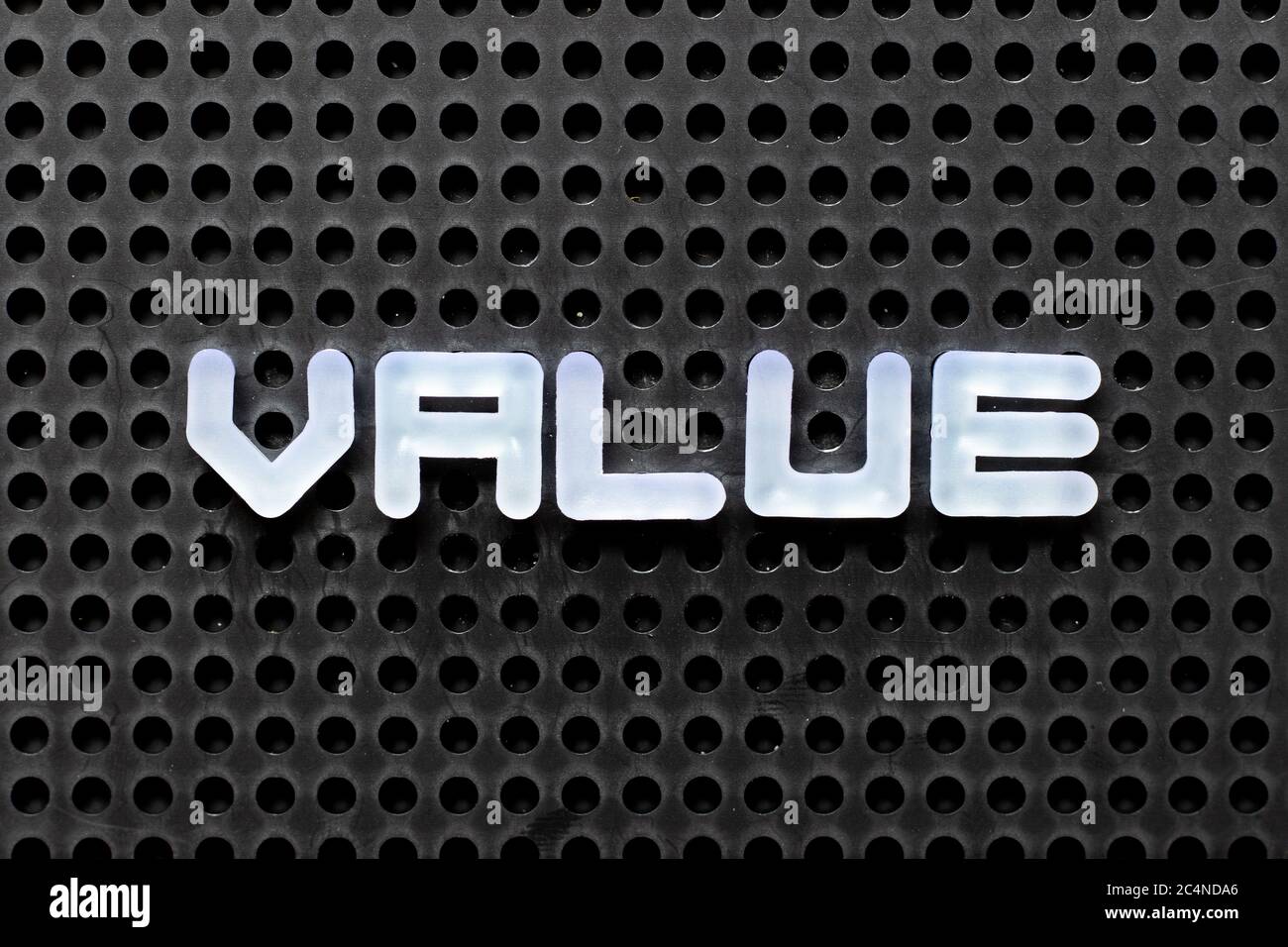 White color alphabet with word value on black pegboard background Stock ...
