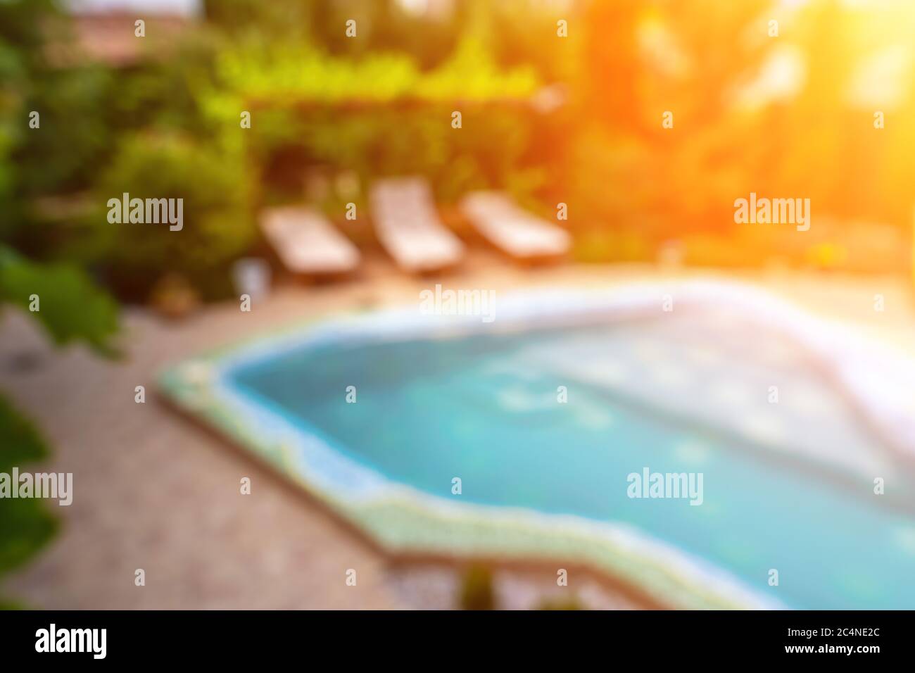 Abstract blur for background. Blue swimming pool with sunbeds in hotel ...