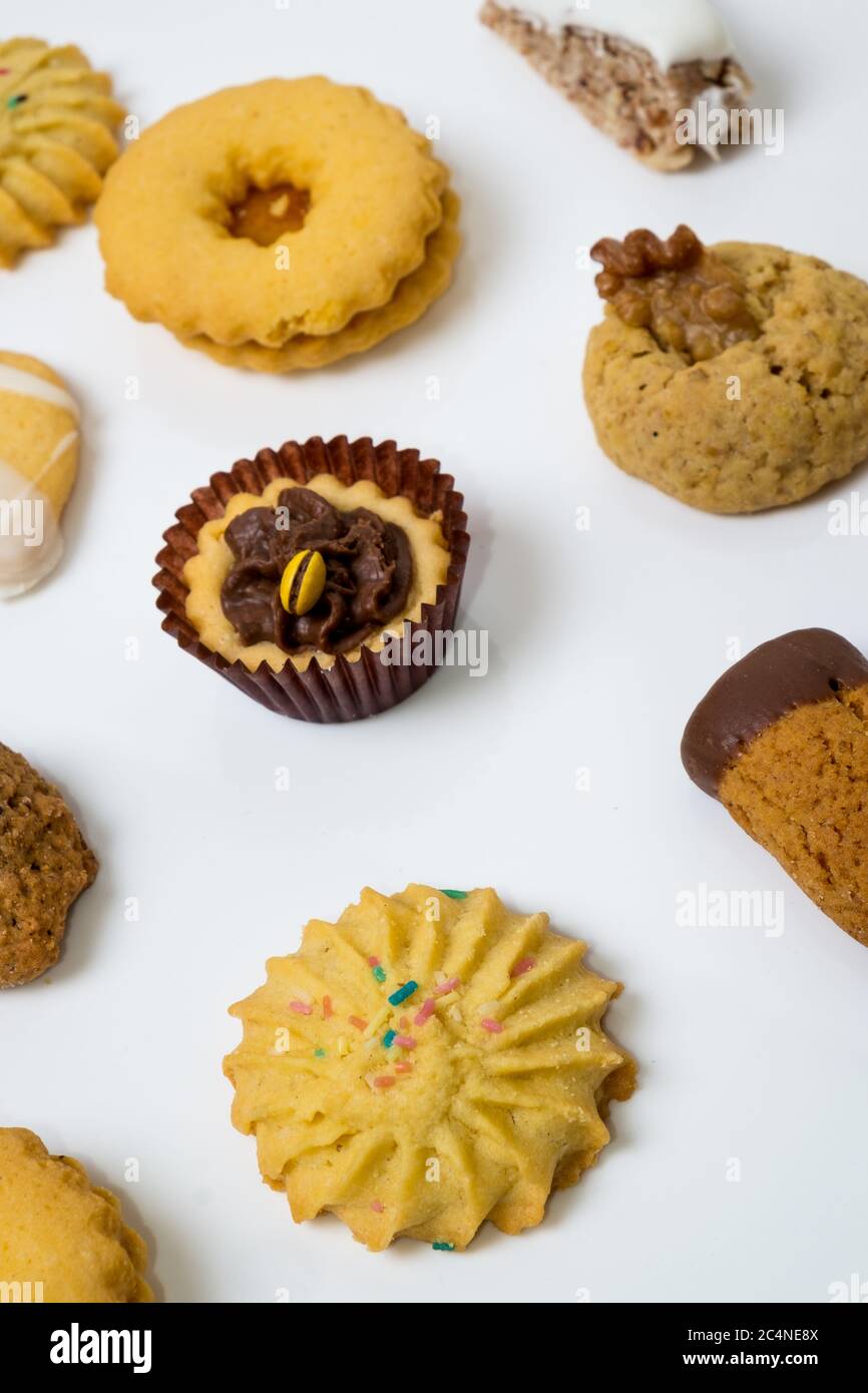 Vertical shot of different kind of cookies isolated on a white ...
