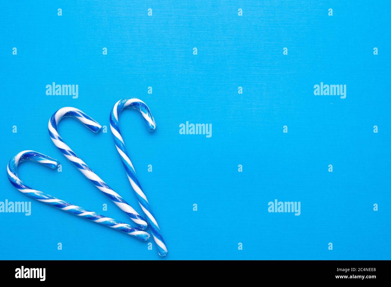 Blue and white candy canes on a blue background, copy space Stock Photo ...