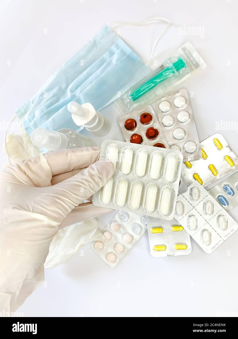 Tablets pills in hand in glove of a woman on white background with many ...